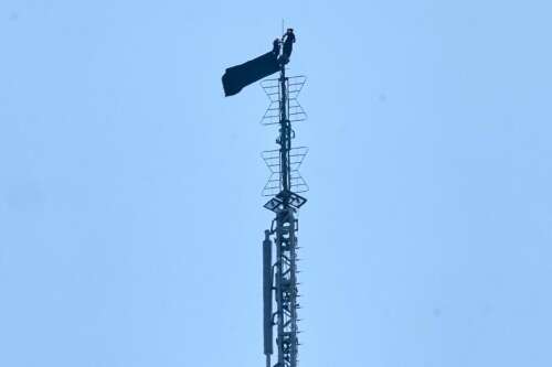 2 people hang banner about 'the power of love' on Empire State Building ...